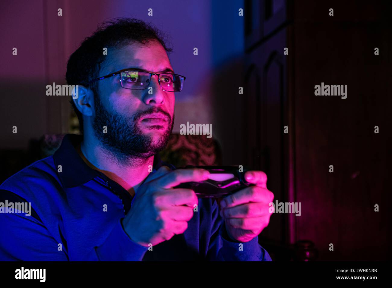 arabic guy playing console games alone Stock Photo - Alamy