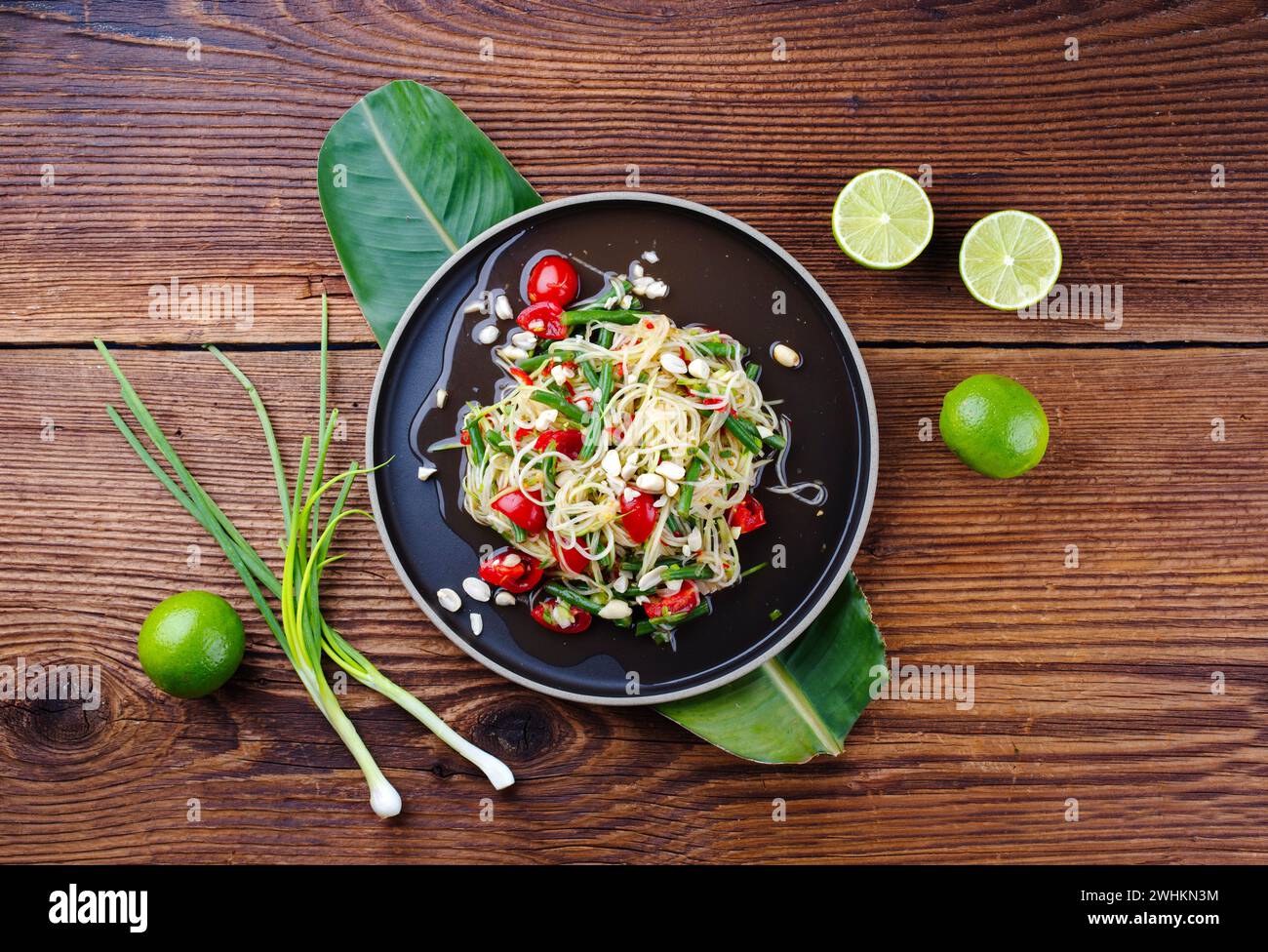 Traditional Thai green papaya som tam salad with green papaya slices ...
