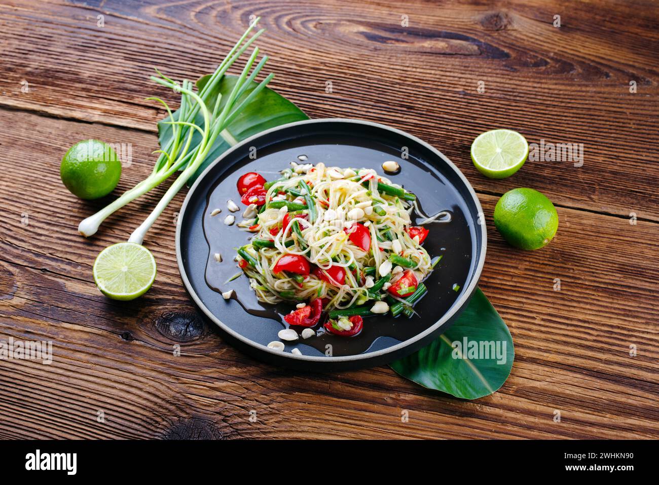 Traditional Thai green papaya som tam salad with green papaya slices ...