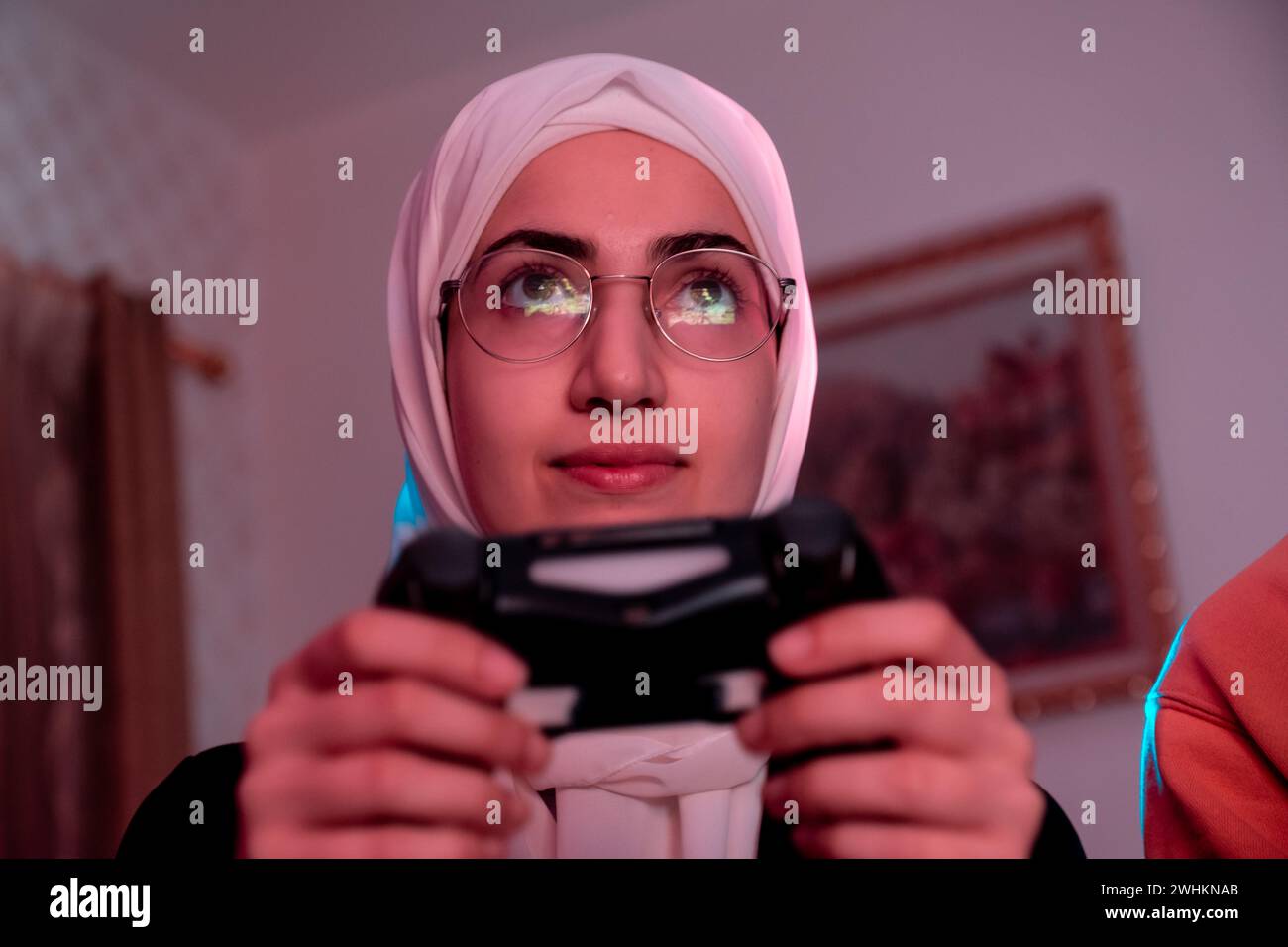 arabic muslim girl playing console games Stock Photo - Alamy