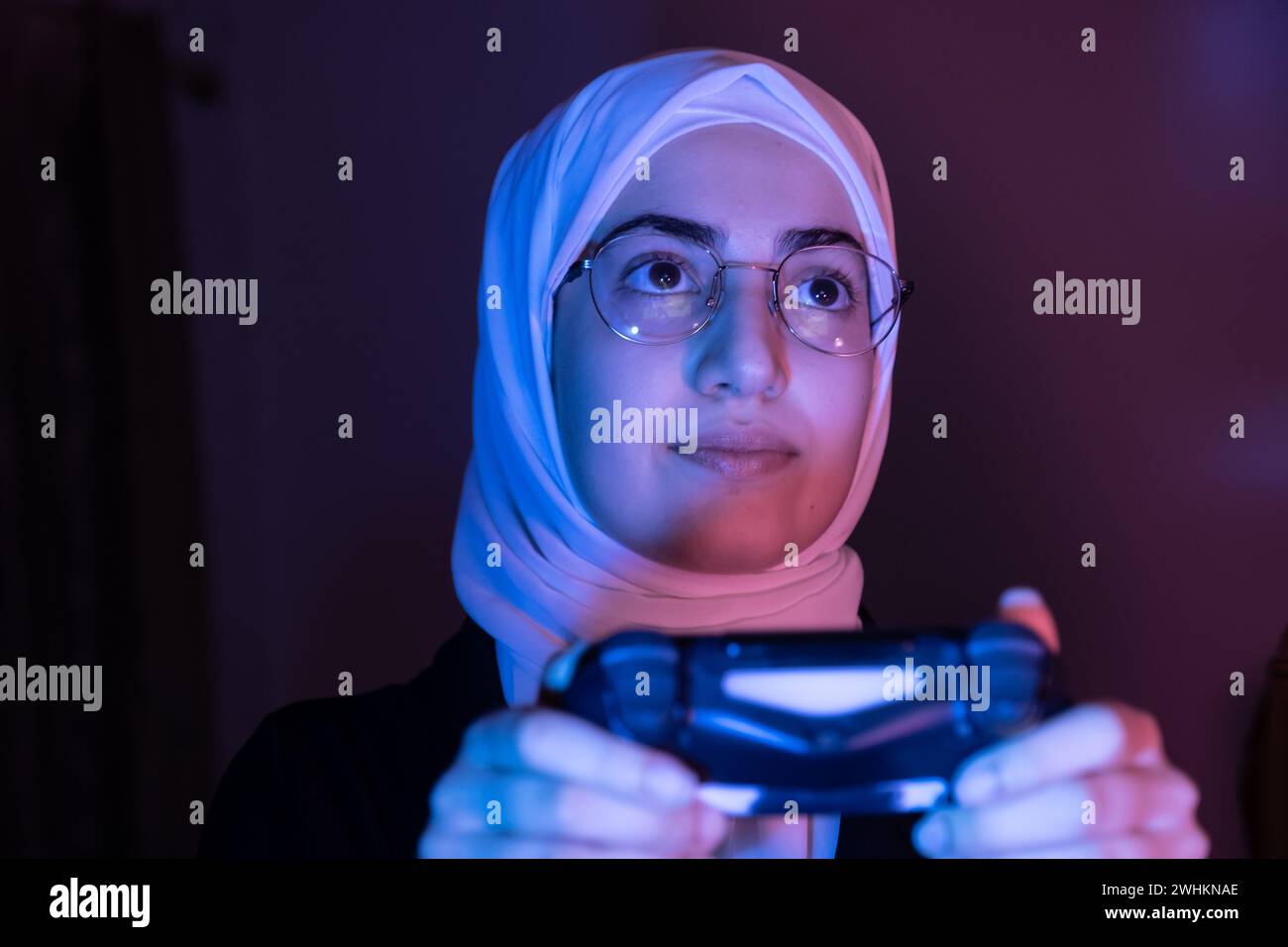 arabic muslim girl playing console games Stock Photo - Alamy