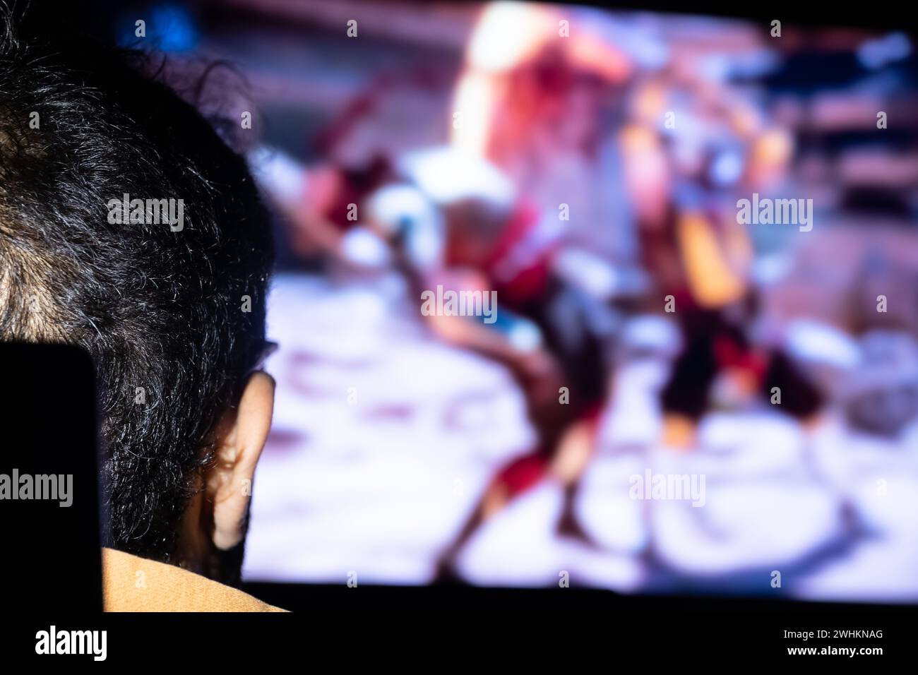 Guy playing console game alone Stock Photo - Alamy
