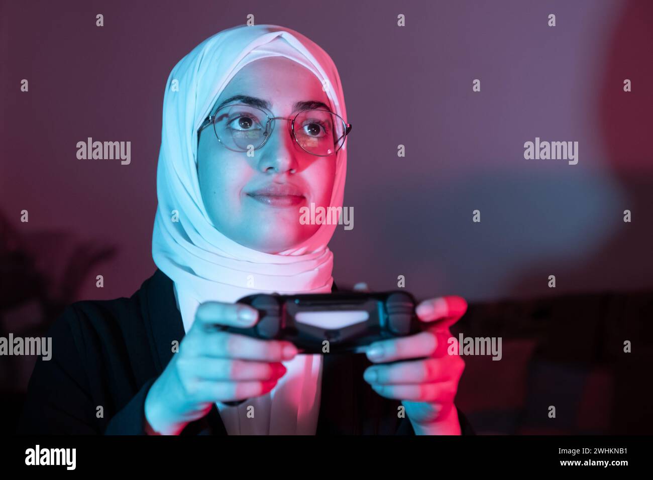 arabic muslim girl playing console games Stock Photo - Alamy