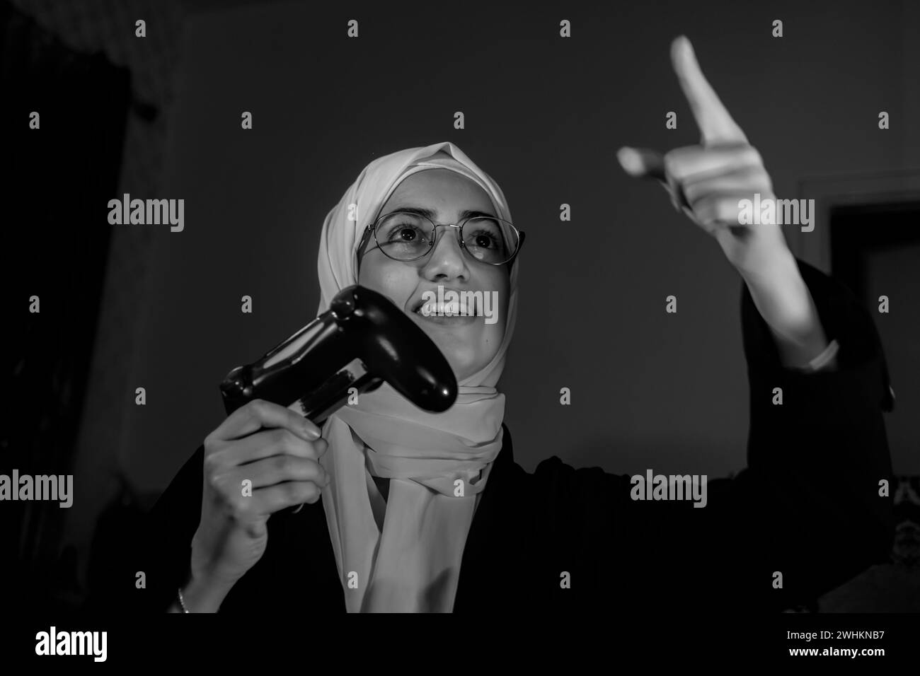 arabic muslim girl playing console games Stock Photo - Alamy