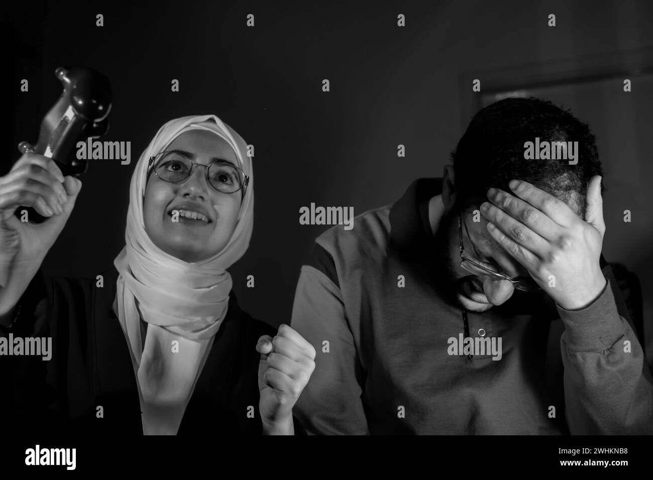 arabic muslim sibling playing together console games Stock Photo - Alamy