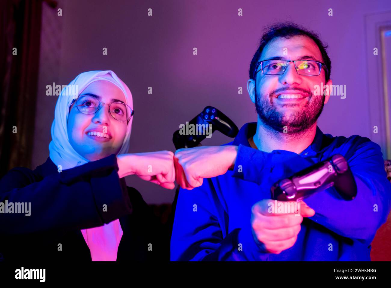 arabic muslim sibling playing together console games Stock Photo - Alamy