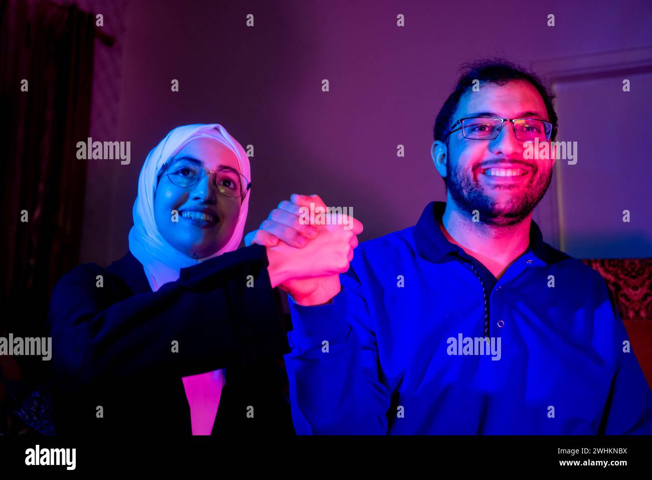 arabic muslim sibling playing together console games Stock Photo - Alamy