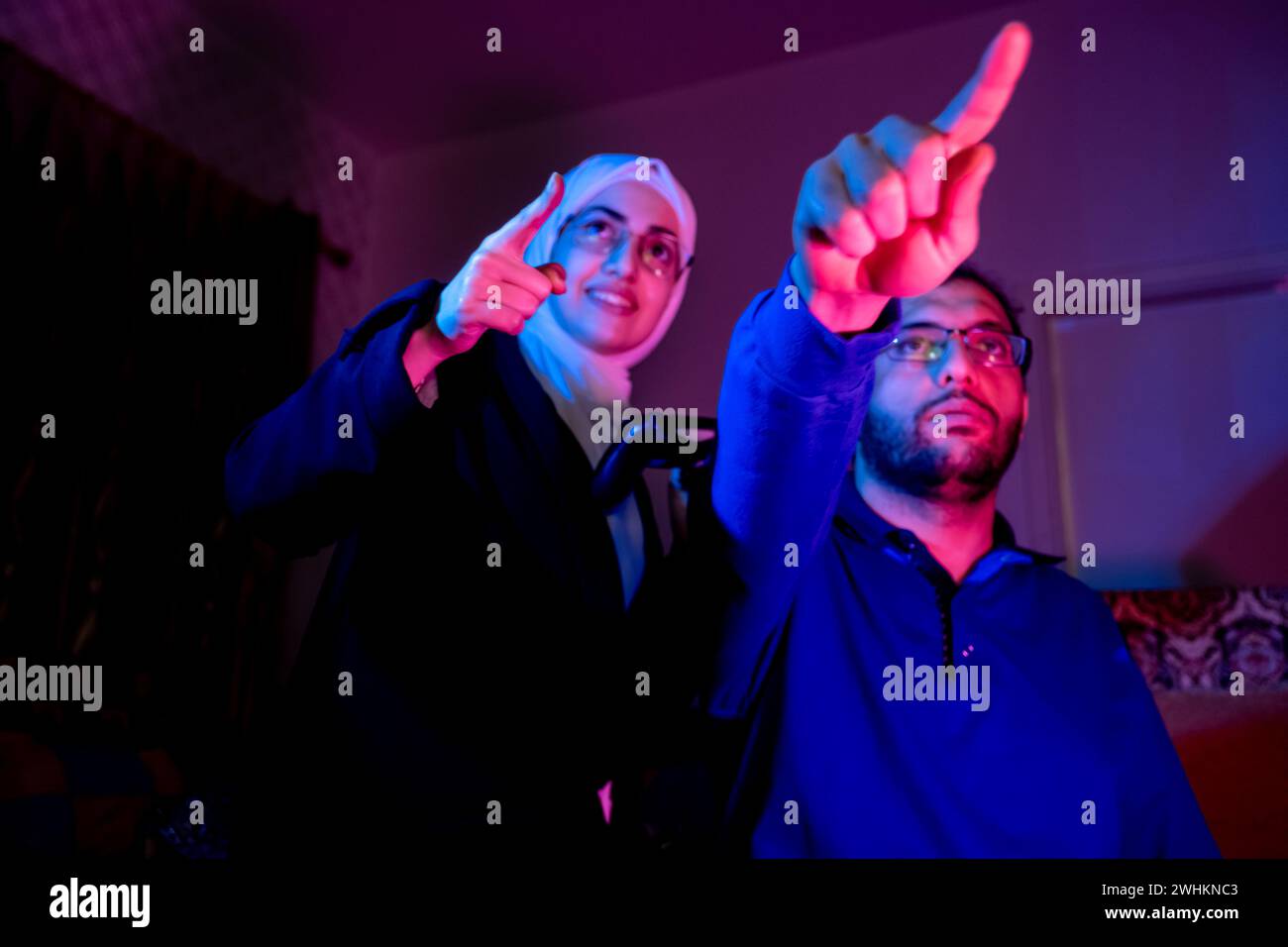 arabic muslim sibling playing together console games Stock Photo - Alamy
