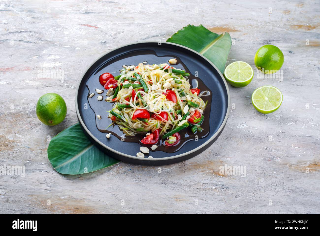 Traditional Thai green papaya som tam salad with green papaya slices ...