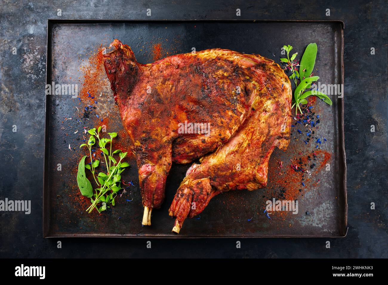 Traditional barbecue half of dairy goat with shoulder and leg served as ...