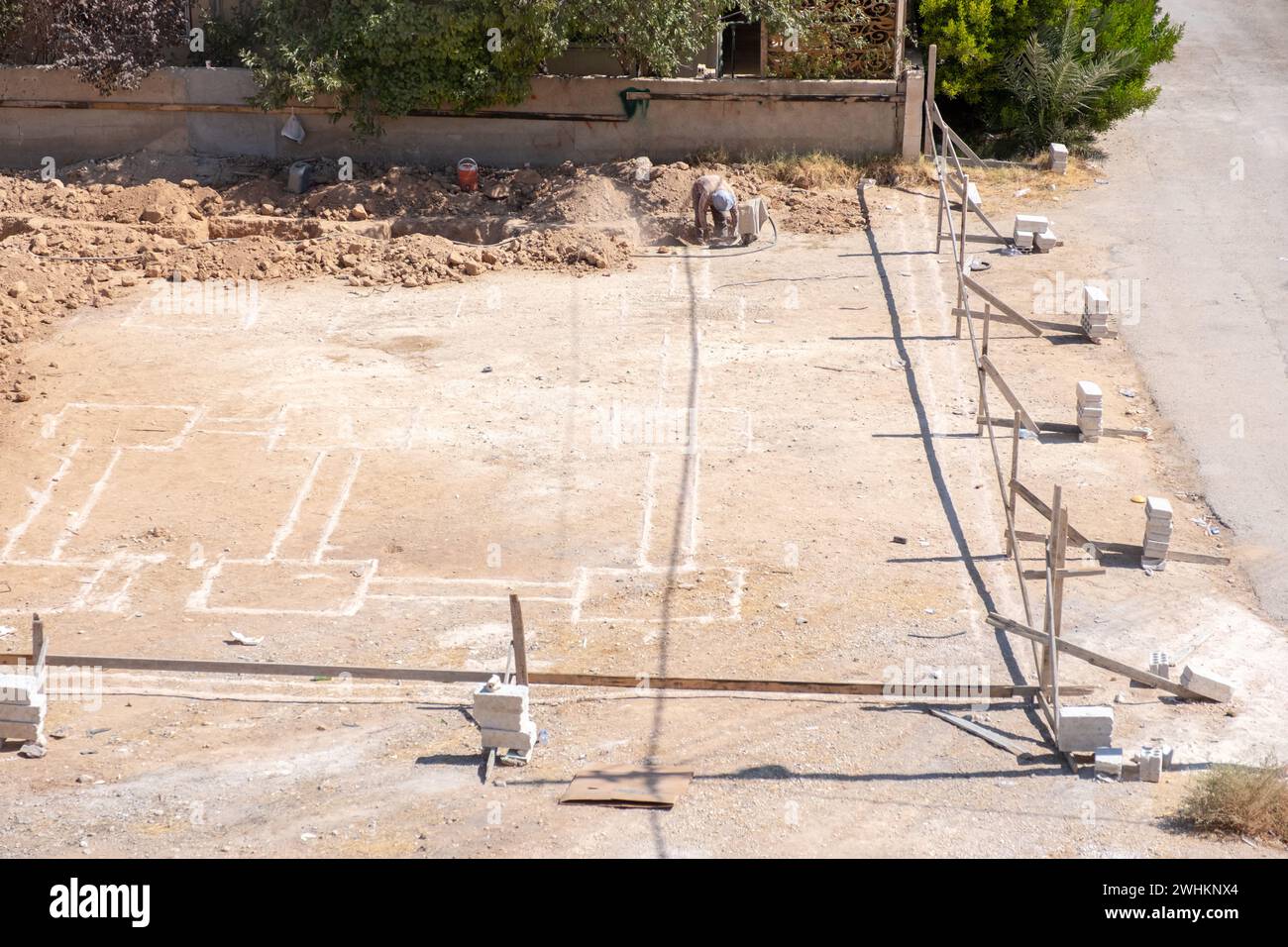 Workers are digging up the foundations for a new house according to the ...