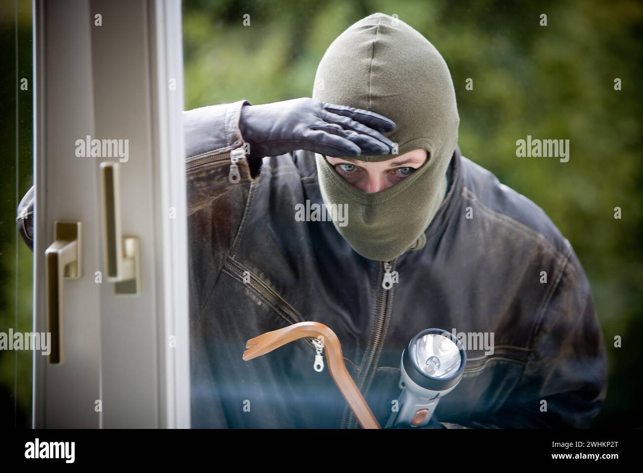 A burglar with a crowbar at a window Stock Photo - Alamy