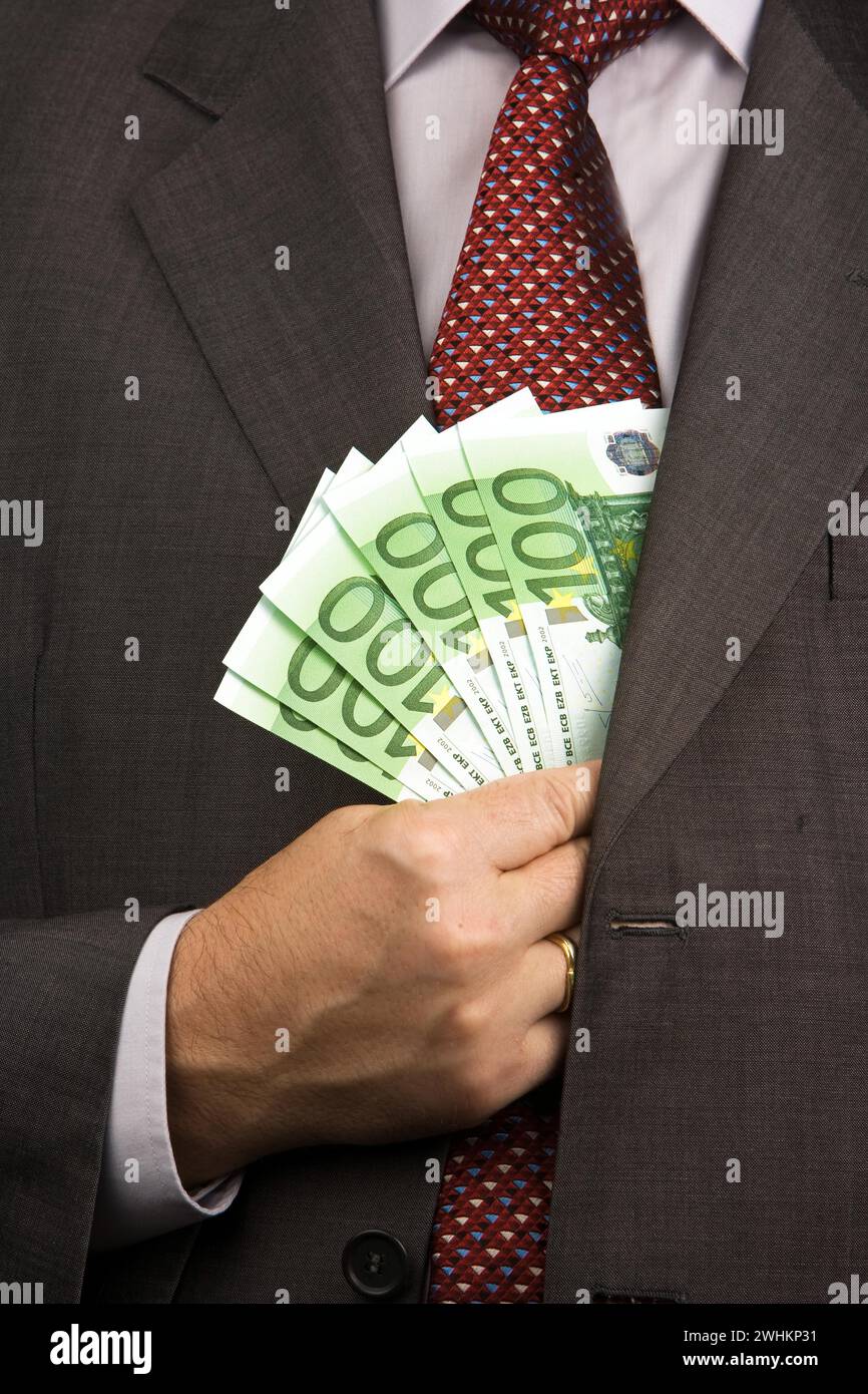 A man in a suit shows various euro banknotes, black money, savings ...
