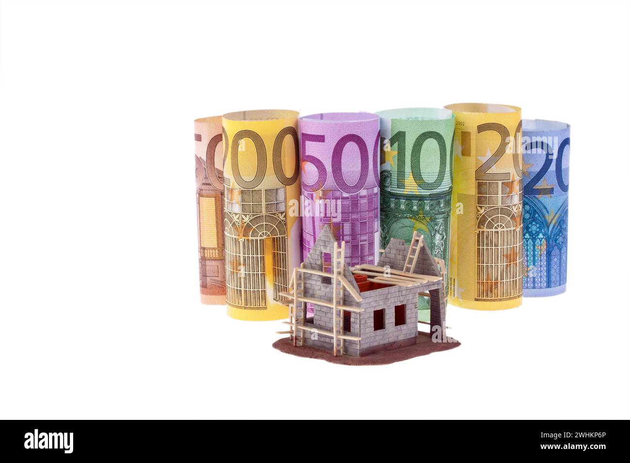 Many euro banknotes and the shell of a house, construction costs ...