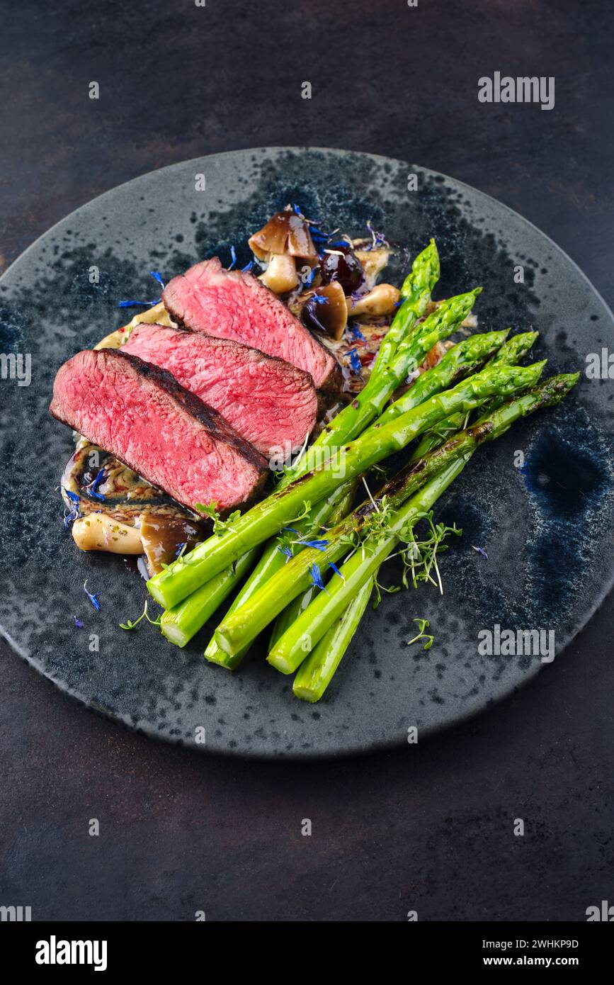 Gourmet barbecue dry aged angus beef steak with green asparagus and ...