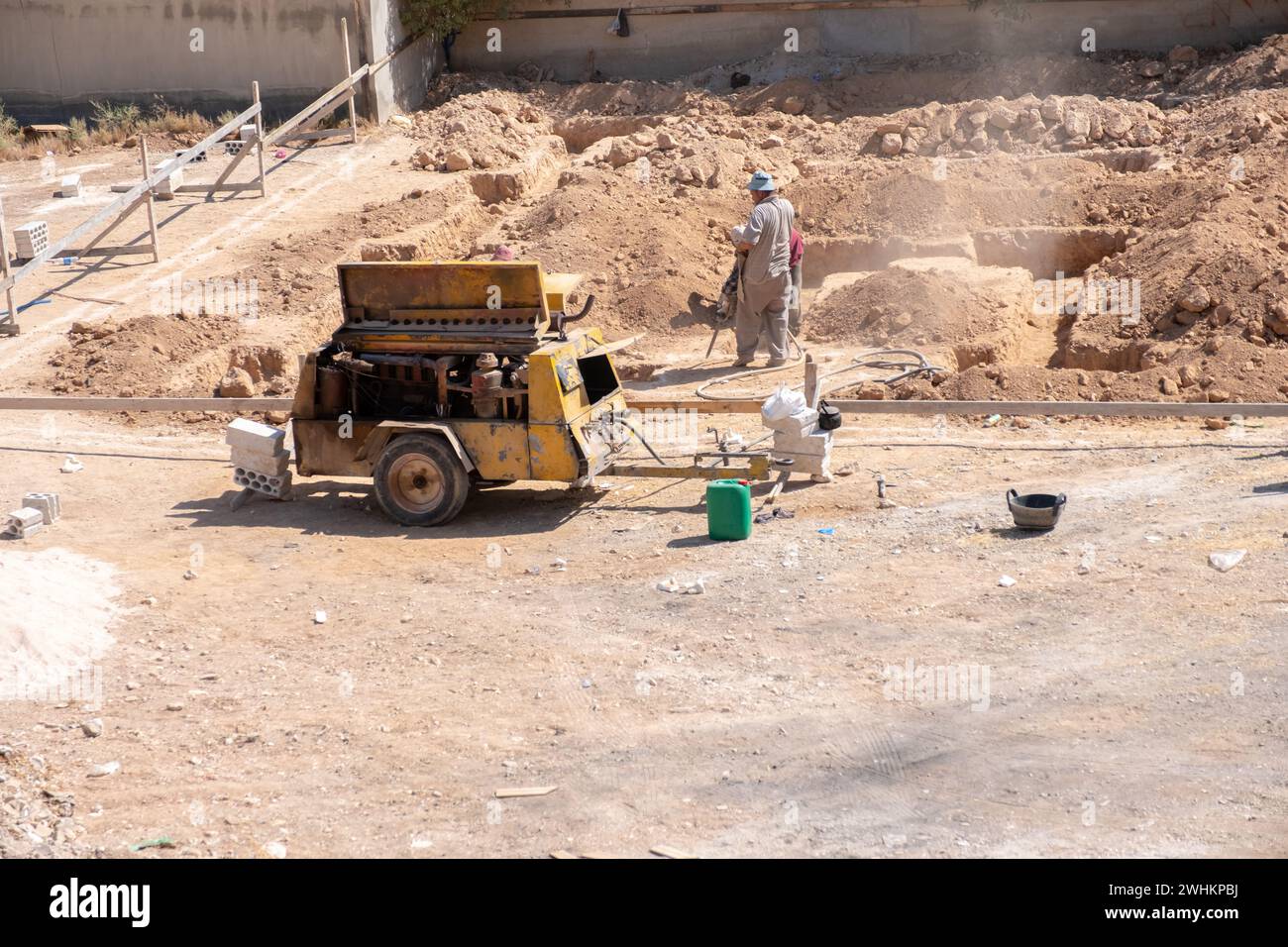 Workers are digging up the foundations for a new house according to the ...