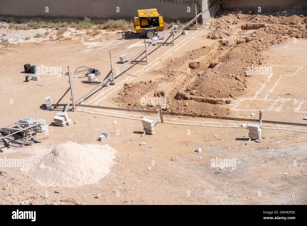 Workers are digging up the foundations for a new house according to the ...