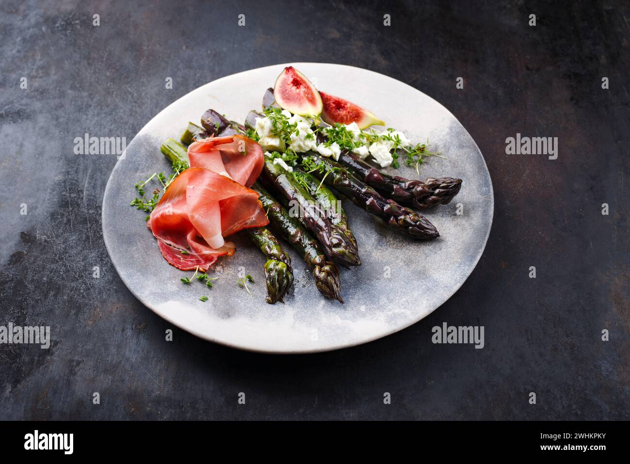 Traditional glazed purple asparagus with prosciutto ham Stock Photo - Alamy