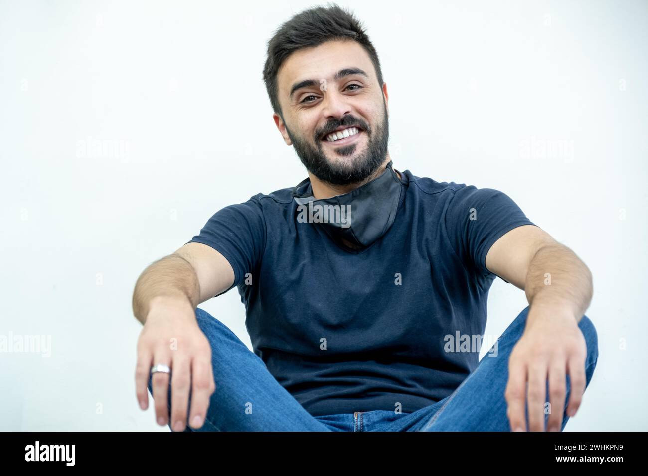 Arabic cheerful man with mask around his neck Stock Photo - Alamy