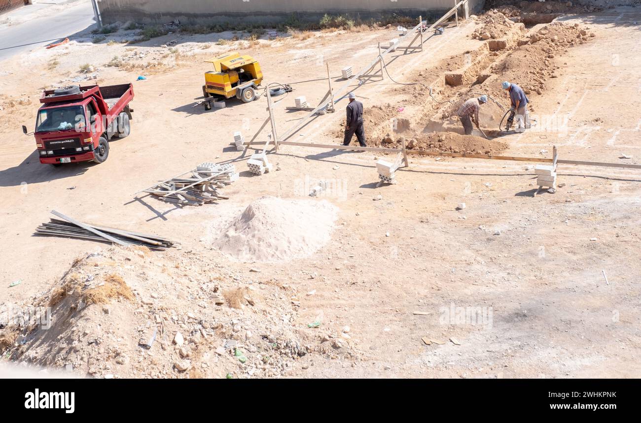 Workers are digging up the foundations for a new house according to the ...