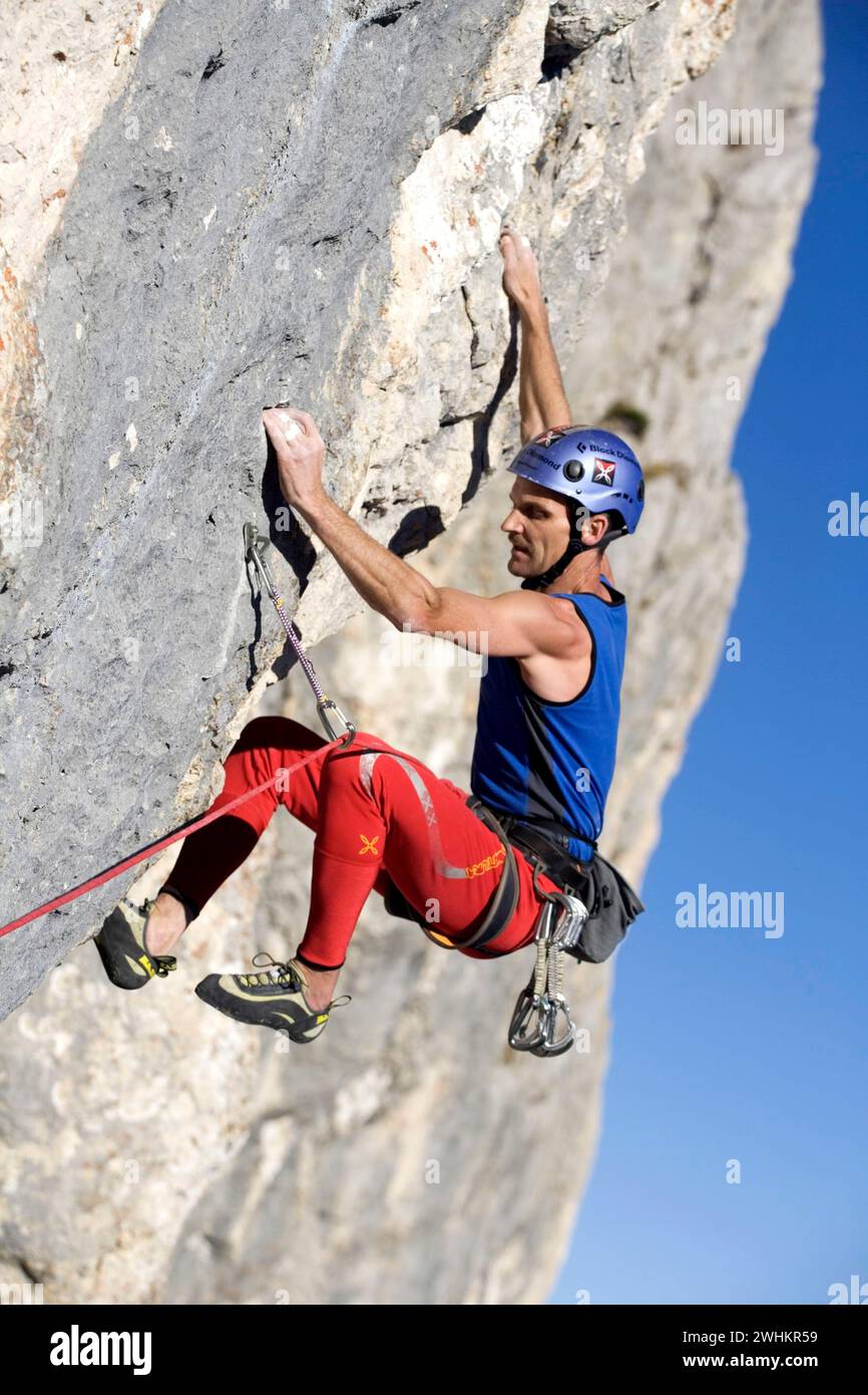 A man climbing on a mountain, helmet, alpine equipment, Lake Garda ...