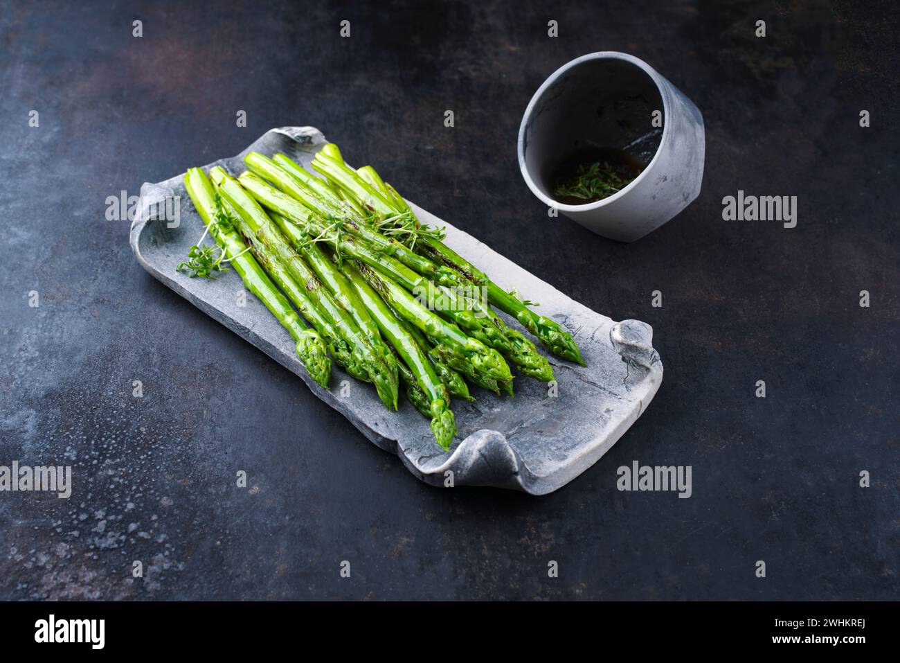 Green asparagus glazed with cress as garnish served as close-up on a ...
