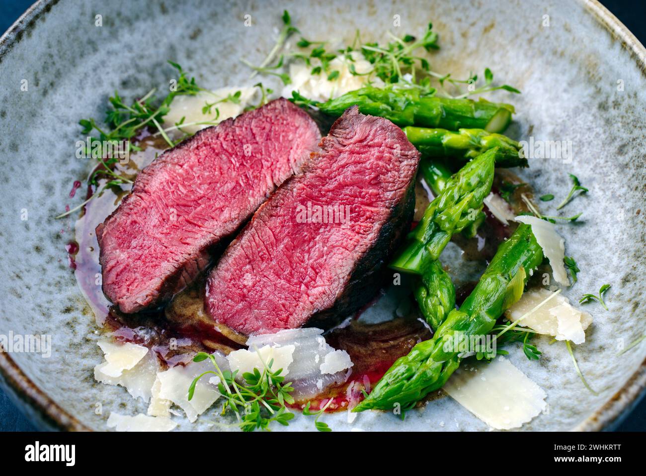Gourmet barbecue dry aged angus beef steak with green asparagus and ...
