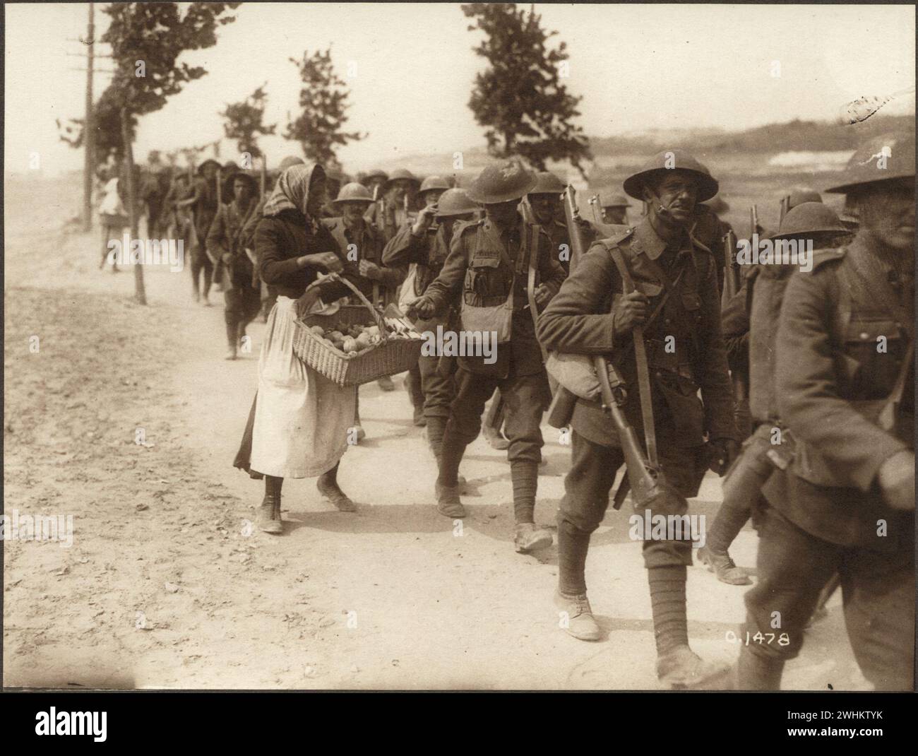French woman selling oranges to Canadian troops on their return to camp ...