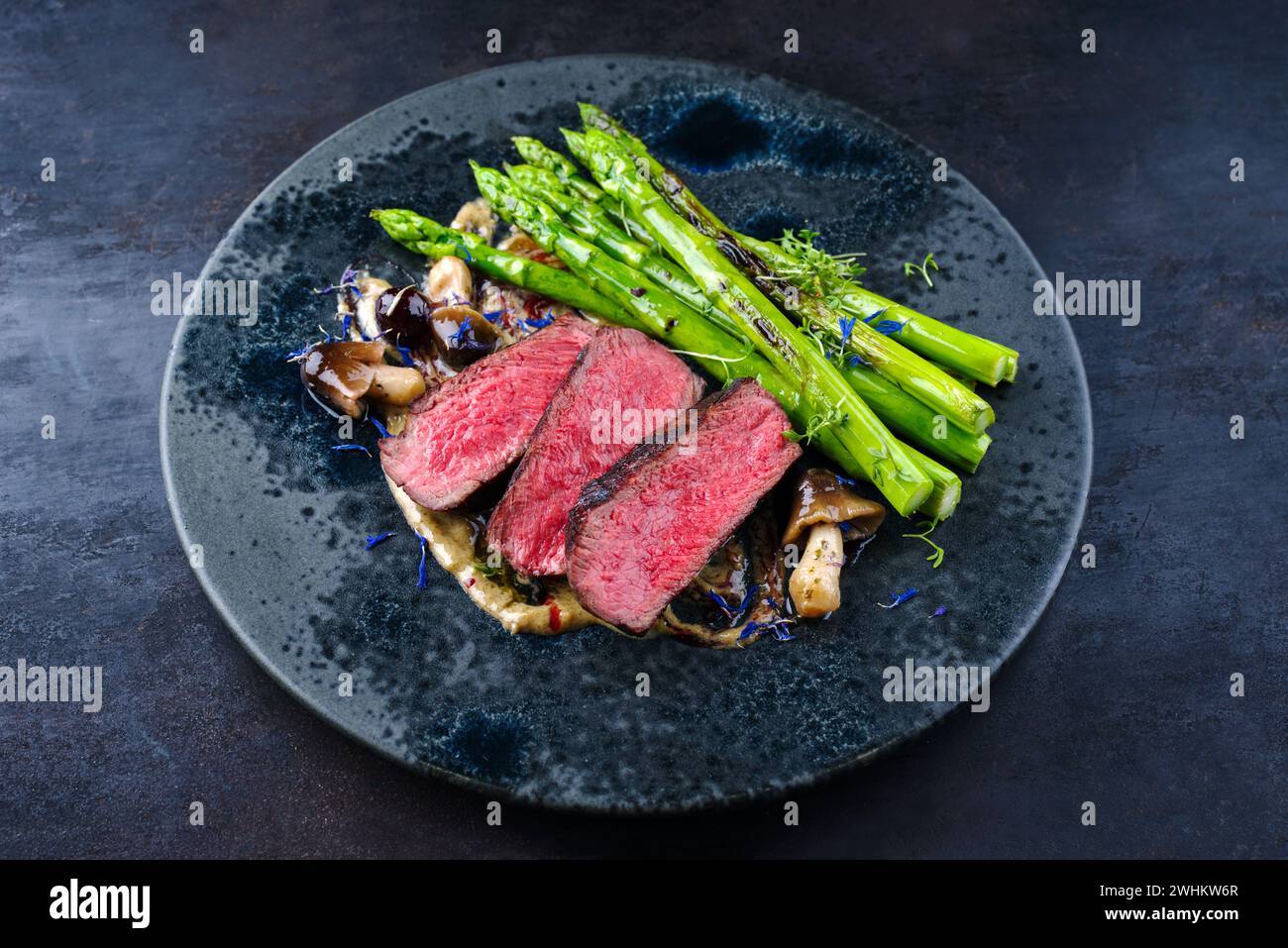 Gourmet barbecue dry aged angus beef steak with green asparagus and ...
