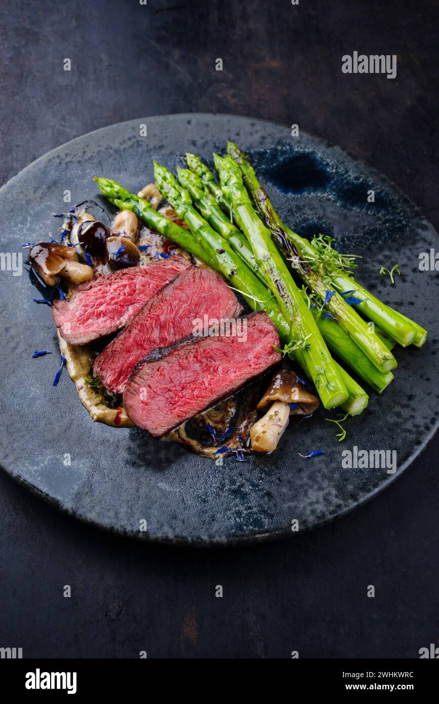 Gourmet barbecue dry aged angus beef steak with green asparagus and ...