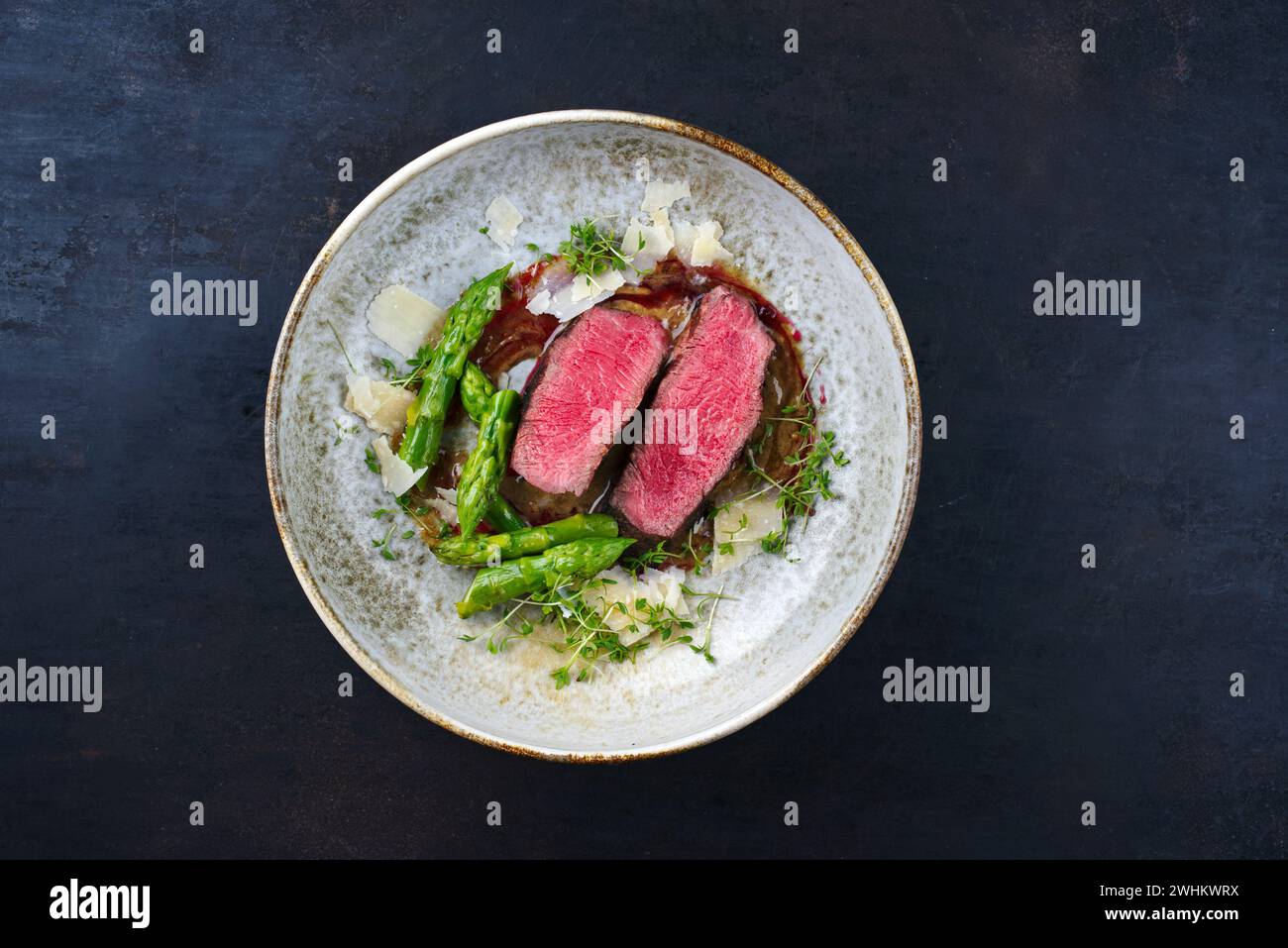 Gourmet barbecue dry aged angus beef steak with green asparagus and ...