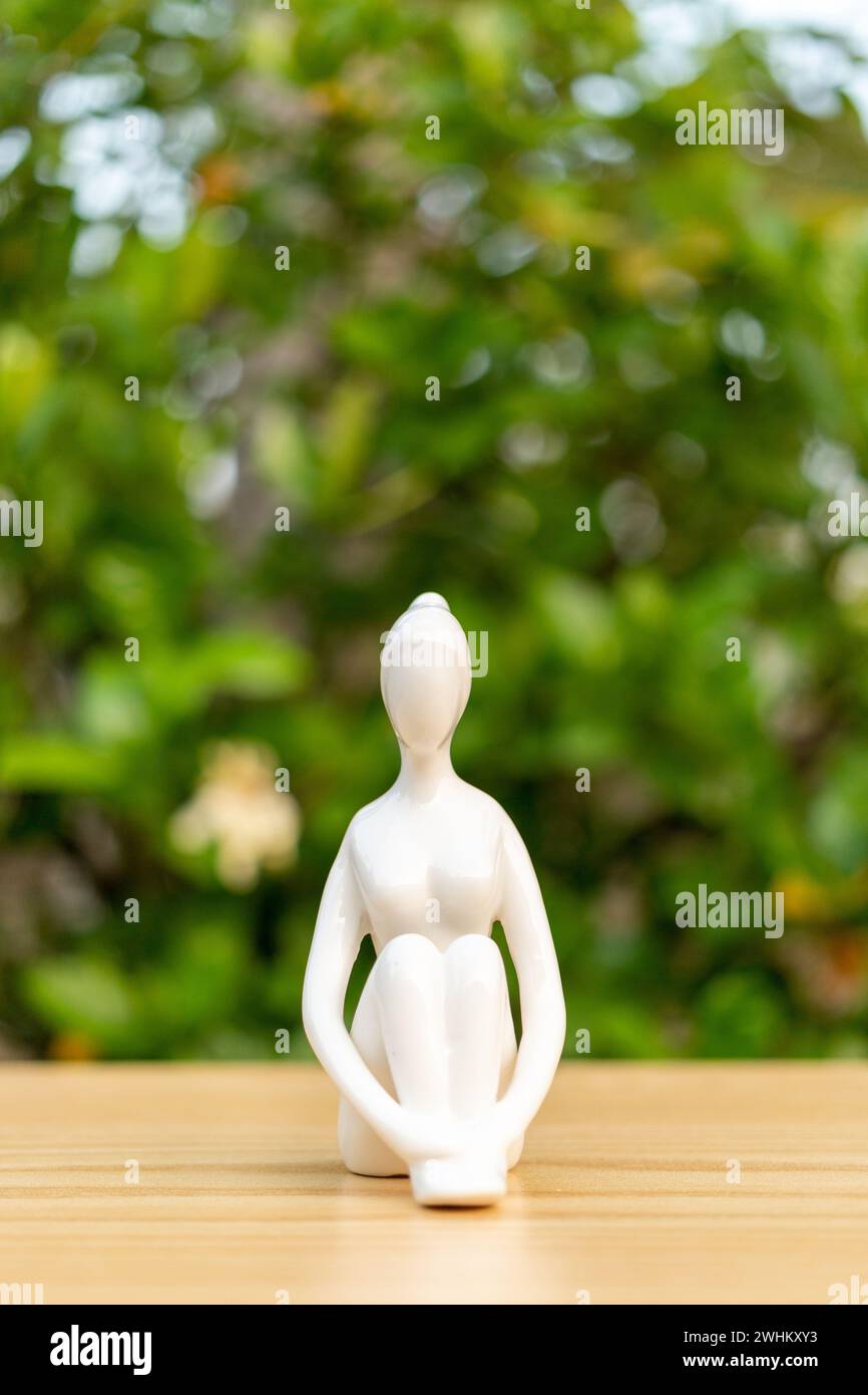 Ceramic Yoga Figurine of Woman doing yoga pose on wooden floor and ...