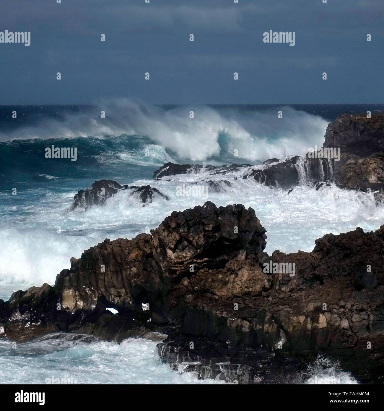 Waves wash over a cliff Stock Photo - Alamy