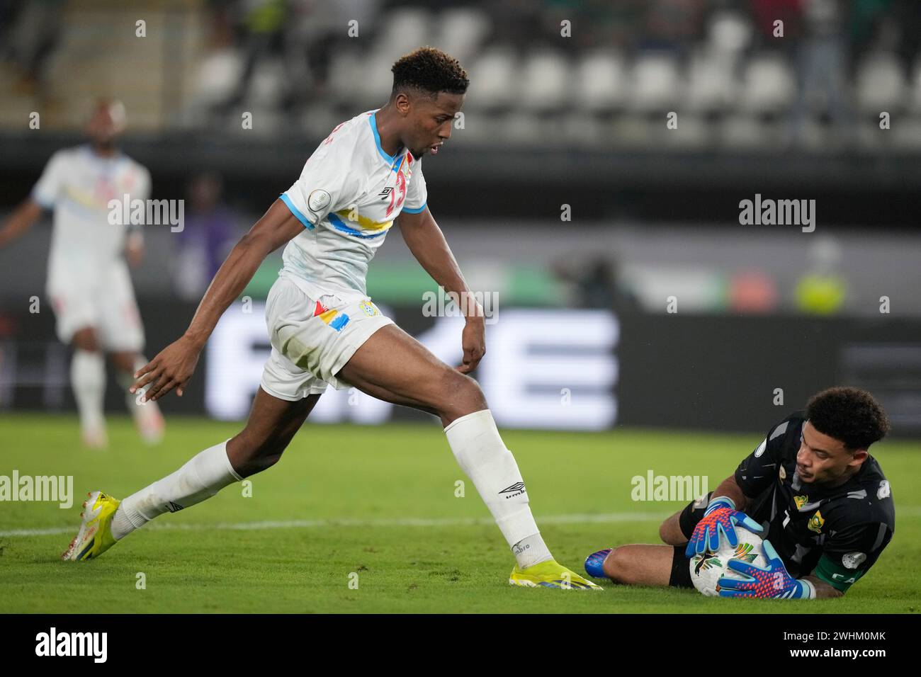 DR Congo's Simon Banza, left, attempts a goal shot as South Africa's ...