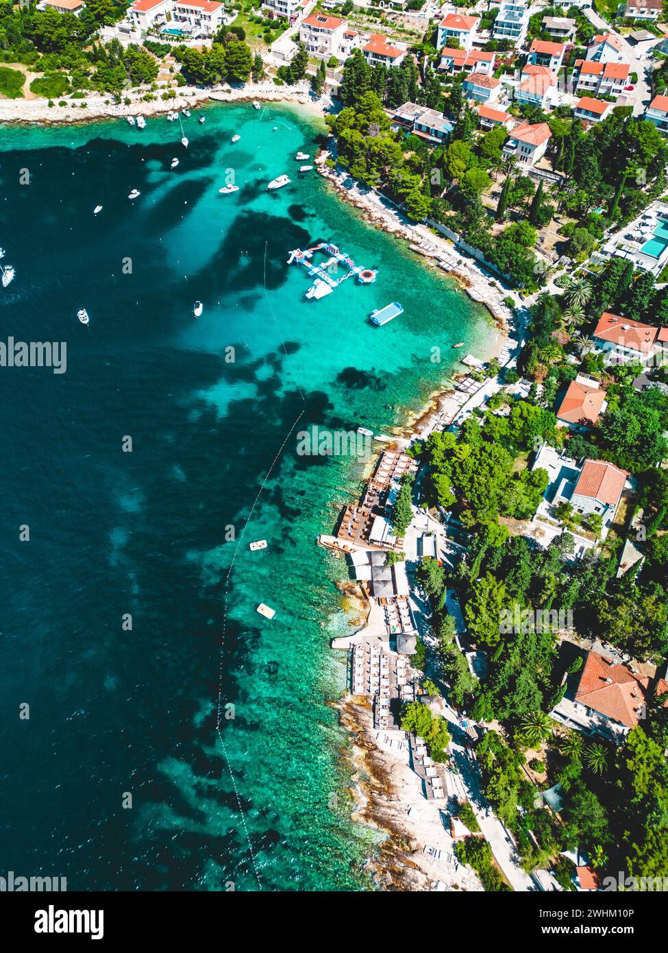 A charming tropical island town with turquoise waters in the foreground ...