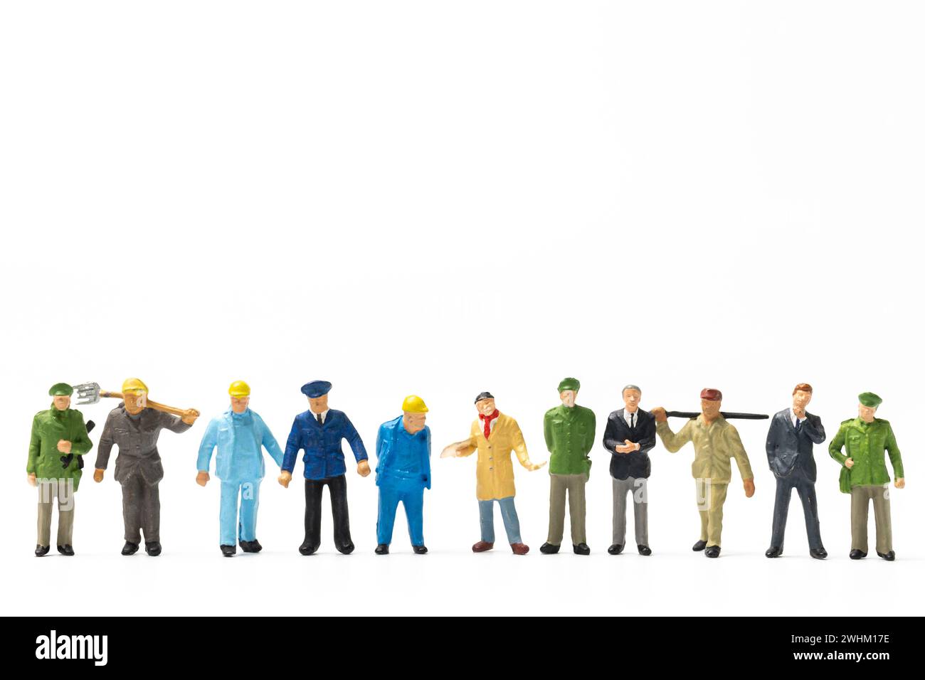 Miniature people different professions standing on white background and ...