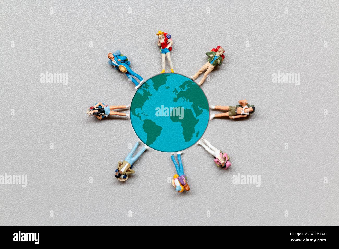 Miniature people standing on the globe with gray background Stock Photo ...