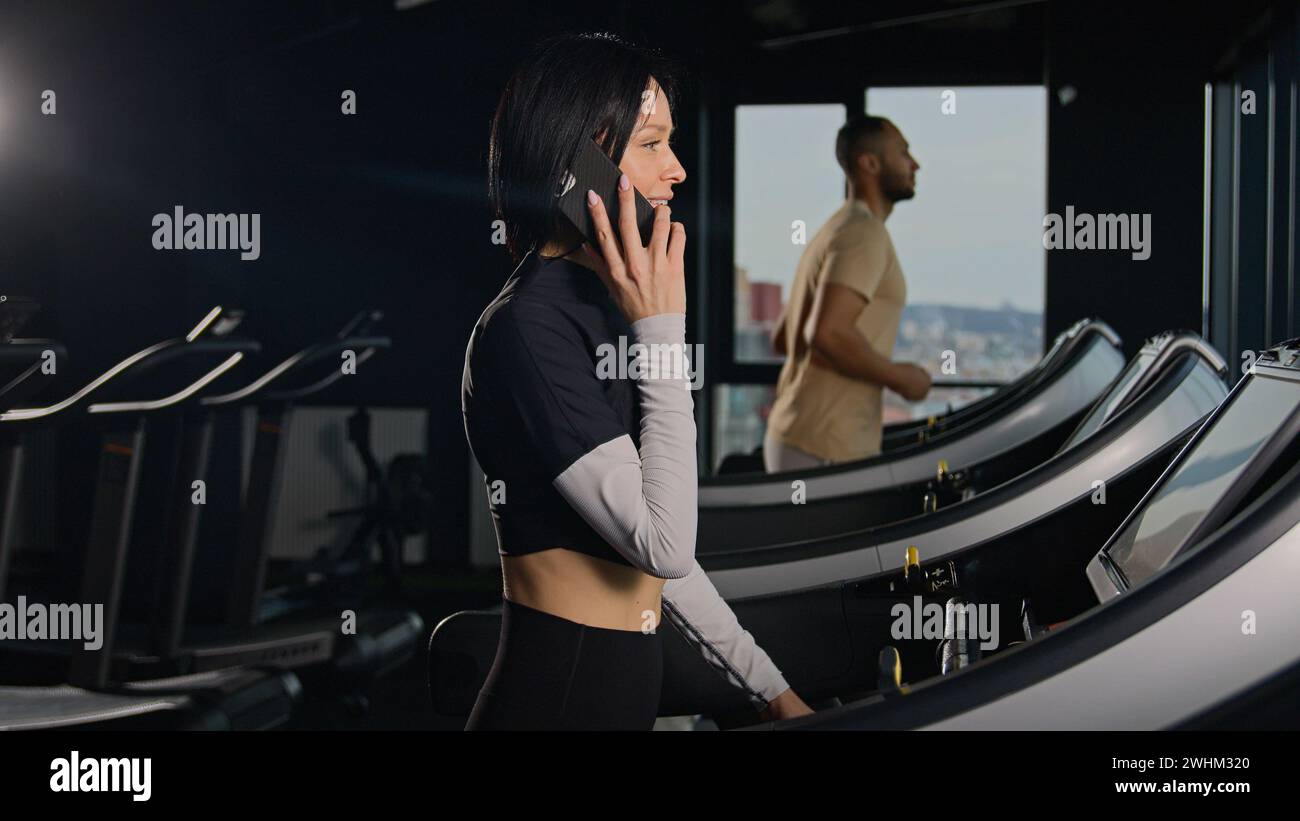 Woman runner talking on phone hi-res stock photography and images - Alamy
