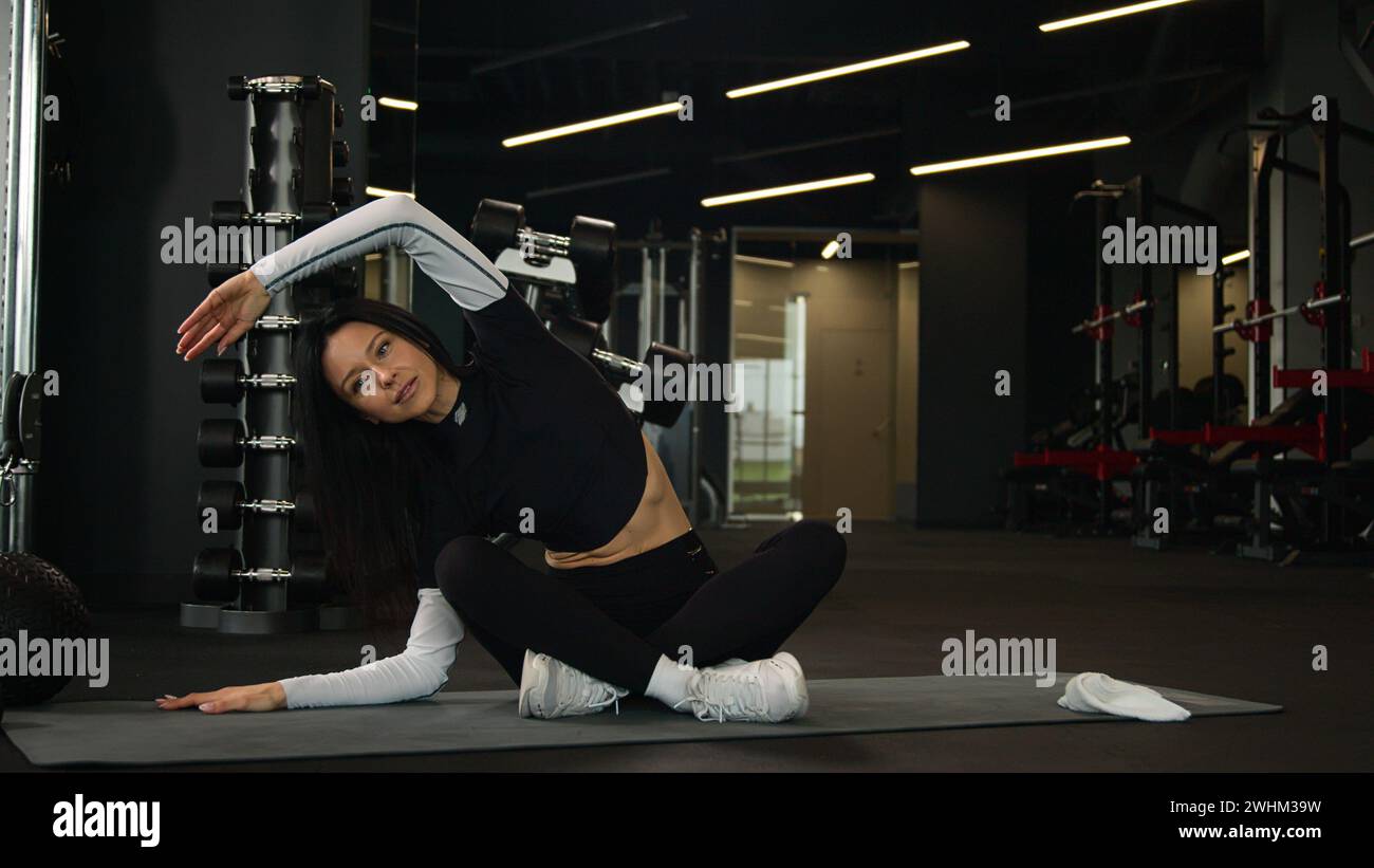 Fit slim Caucasian sportswoman athletic healthy active woman stretch ...