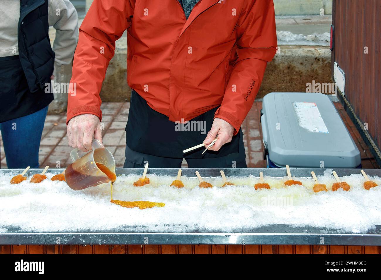 Man creates Maple taffy in the snow. The seasonal treat is a tradition ...