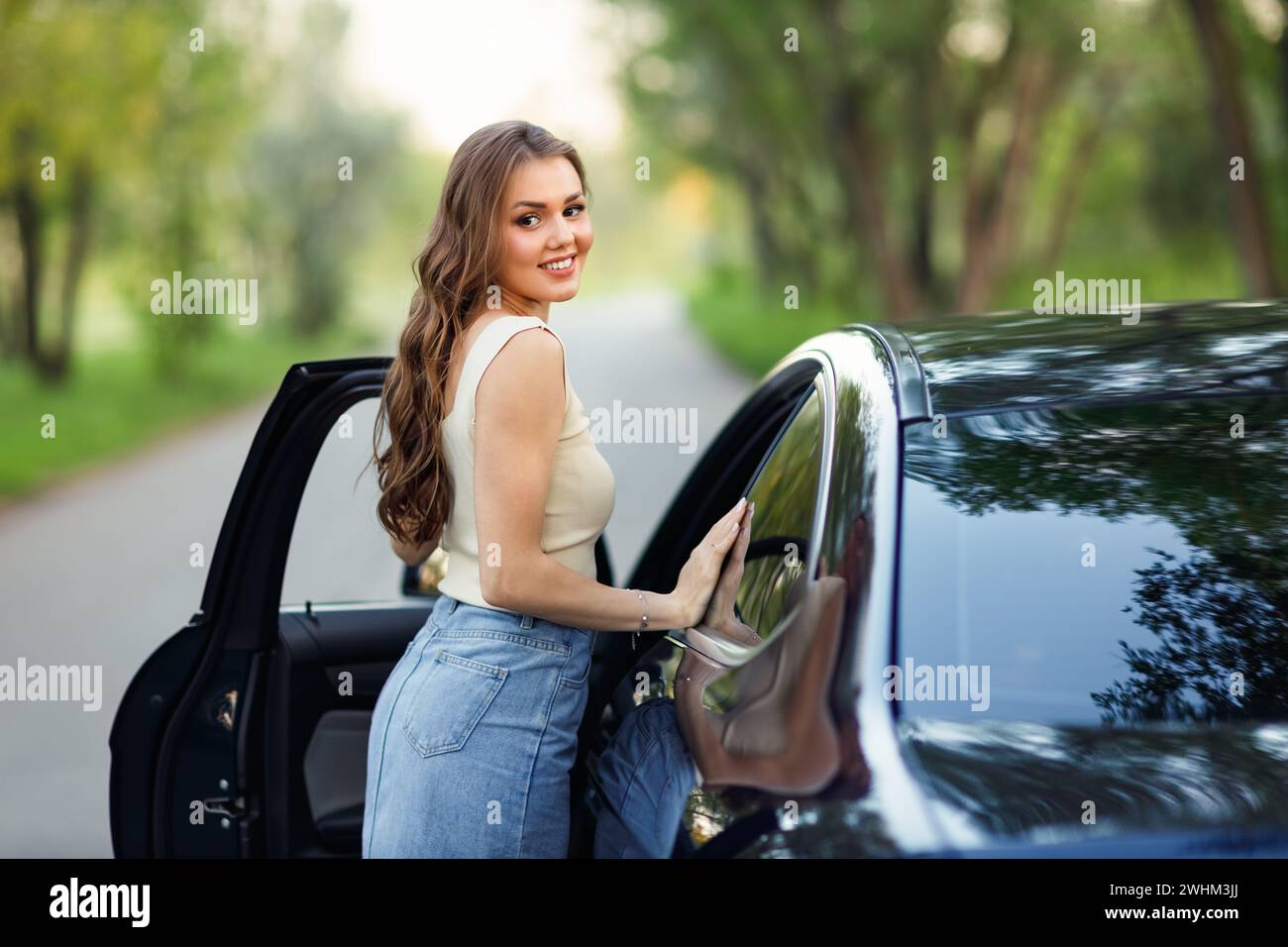 Happy woman driver at car smiling. Cute young happy brunette female ...