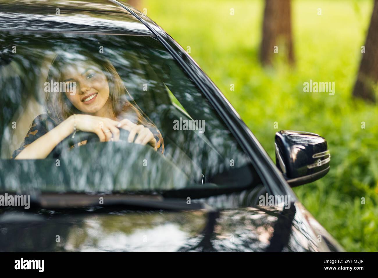 Happy woman driver at car smiling. Cute young happy brunette female ...
