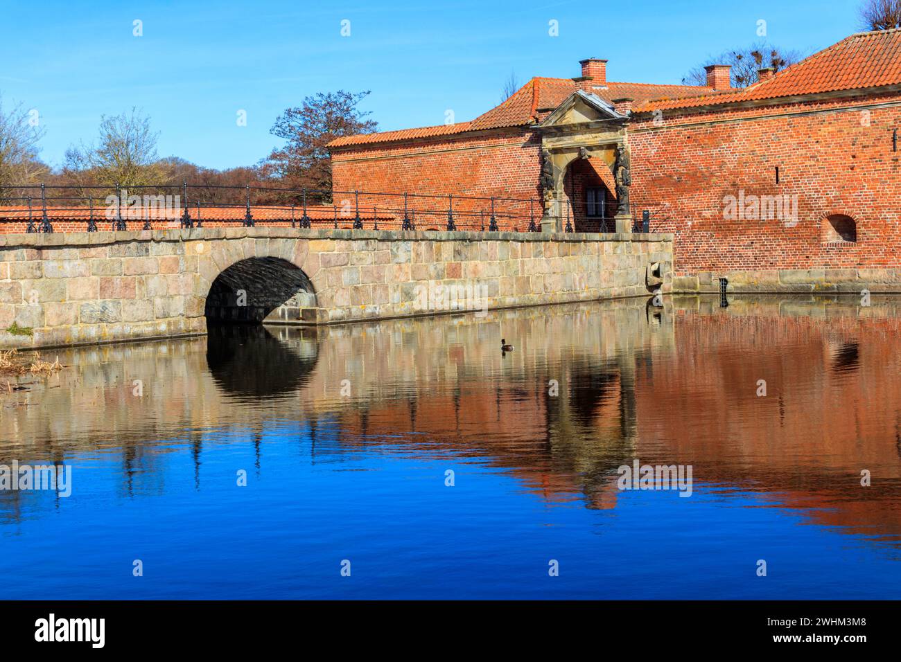 Brick stone bridge across the lake surrounding Frederiksborg castle in ...