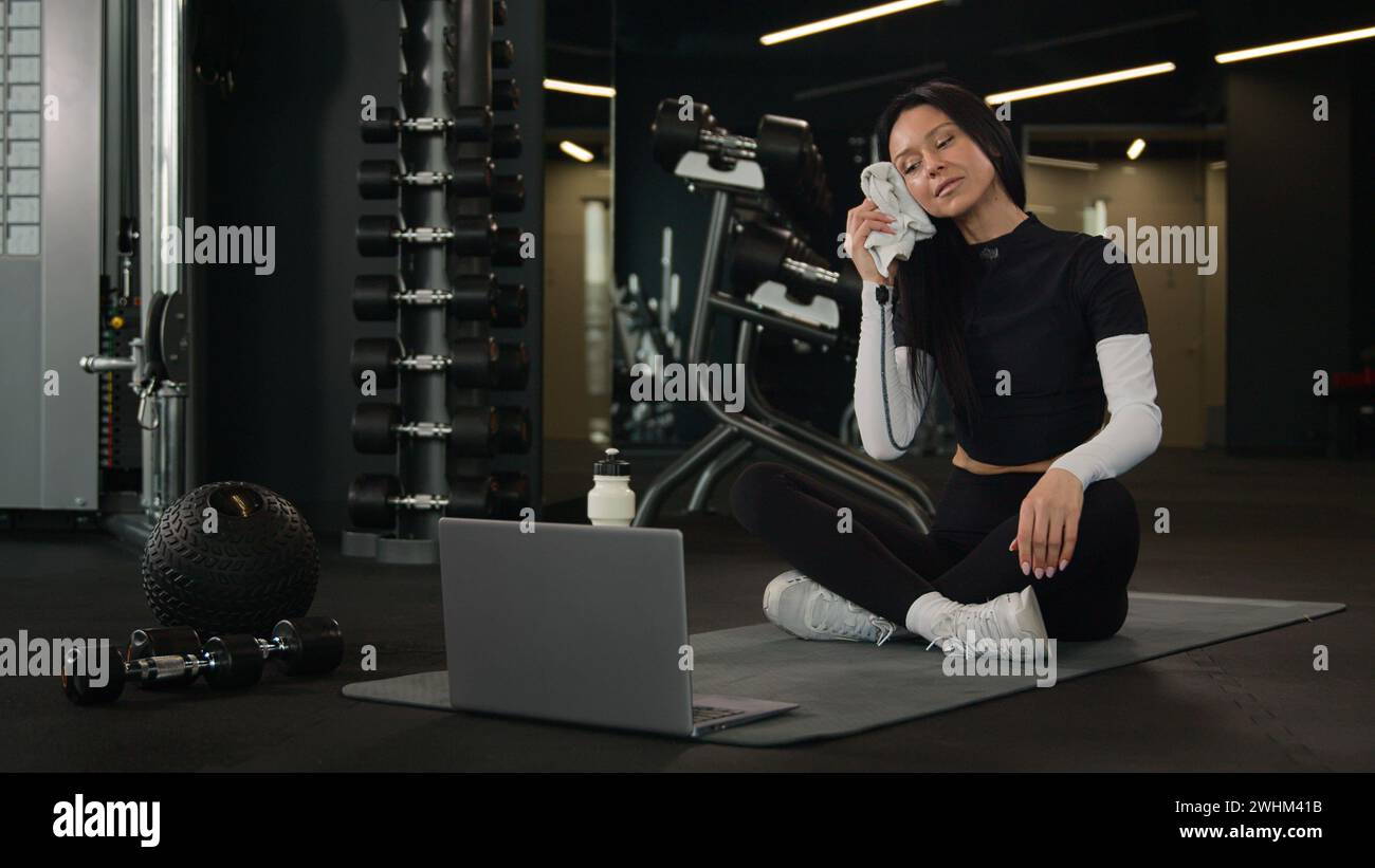 Sport trainer instructor woman teaching online workout with laptop ...