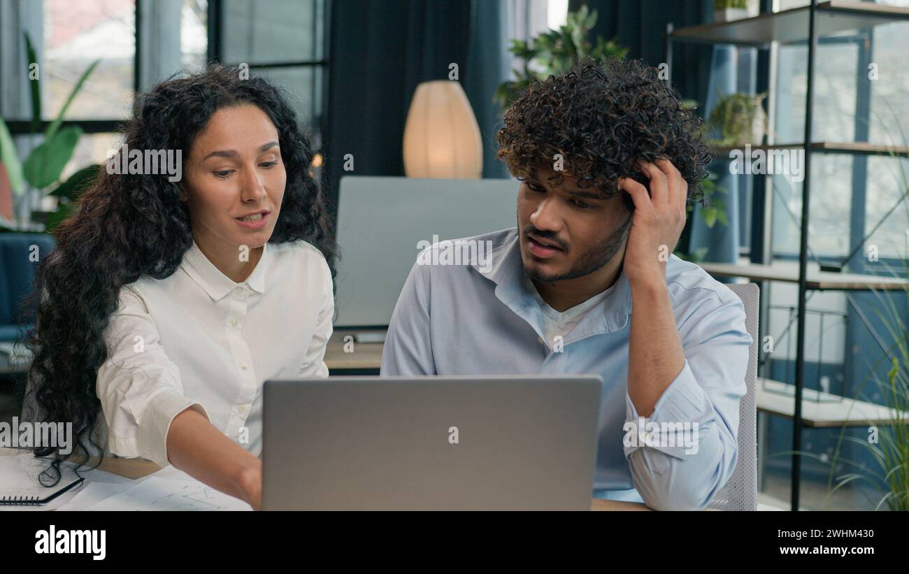 Annoyed woman business mentor teaching male intern help laptop work problem difficulties lazy ...