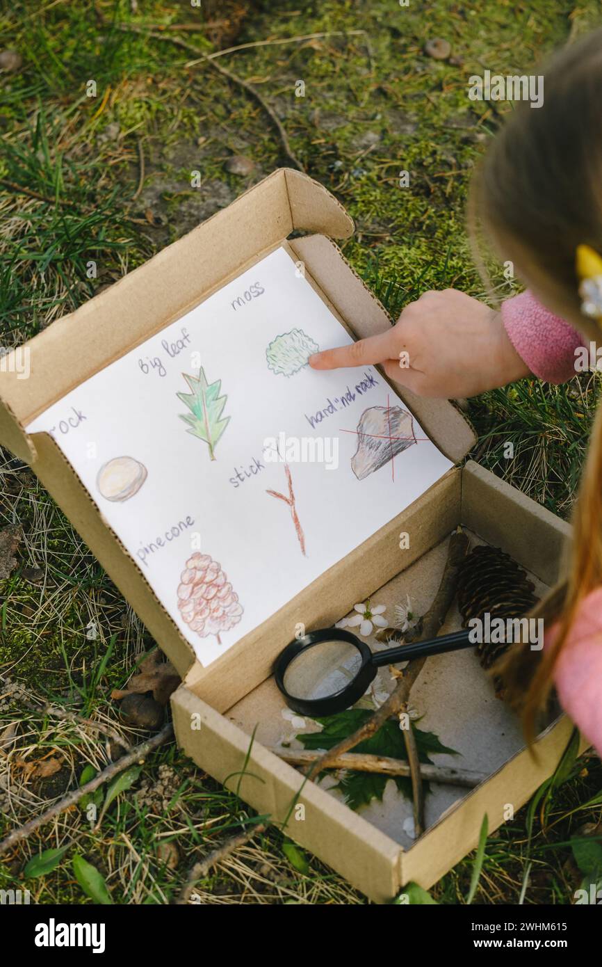 Scavenger hunt for kid in the park. Girl learning about environment ...