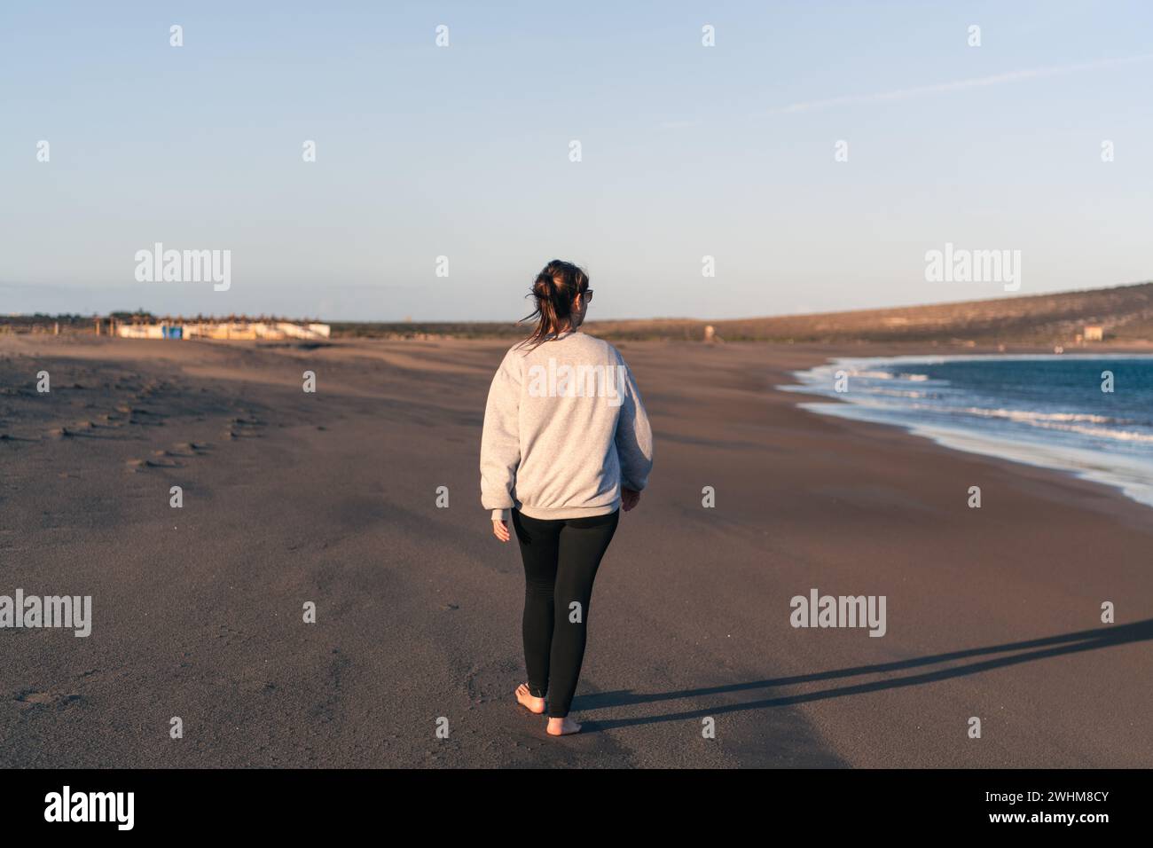 Woman walking on a spanish beach hi-res stock photography and images ...