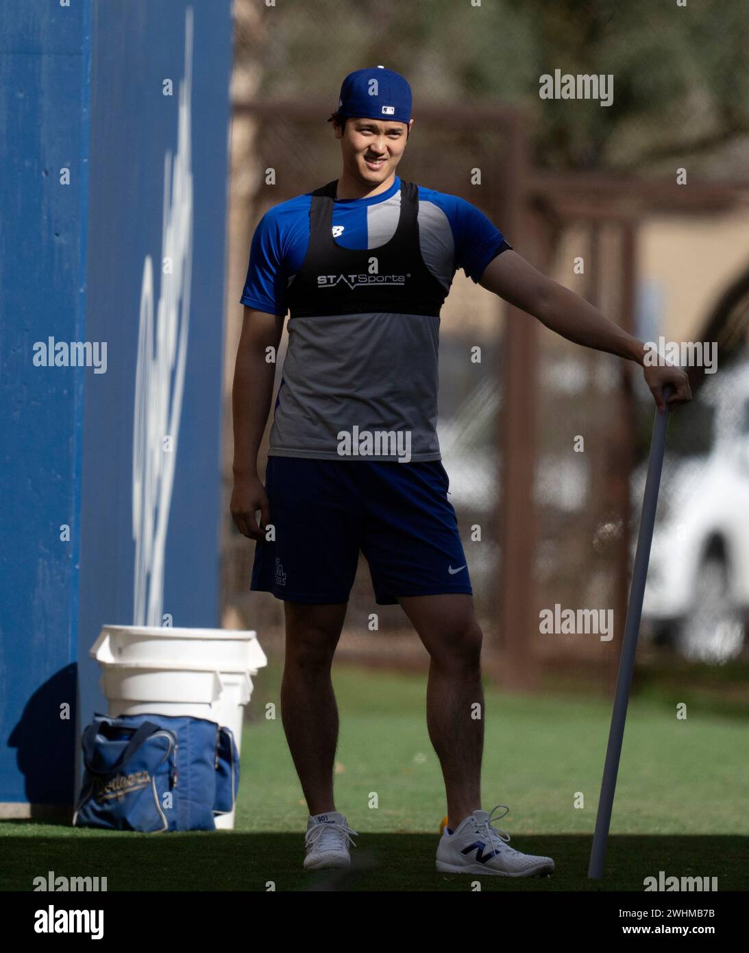 Los Angeles Dodgers Shohei Ohtani pauses as he works with a trainer at ...