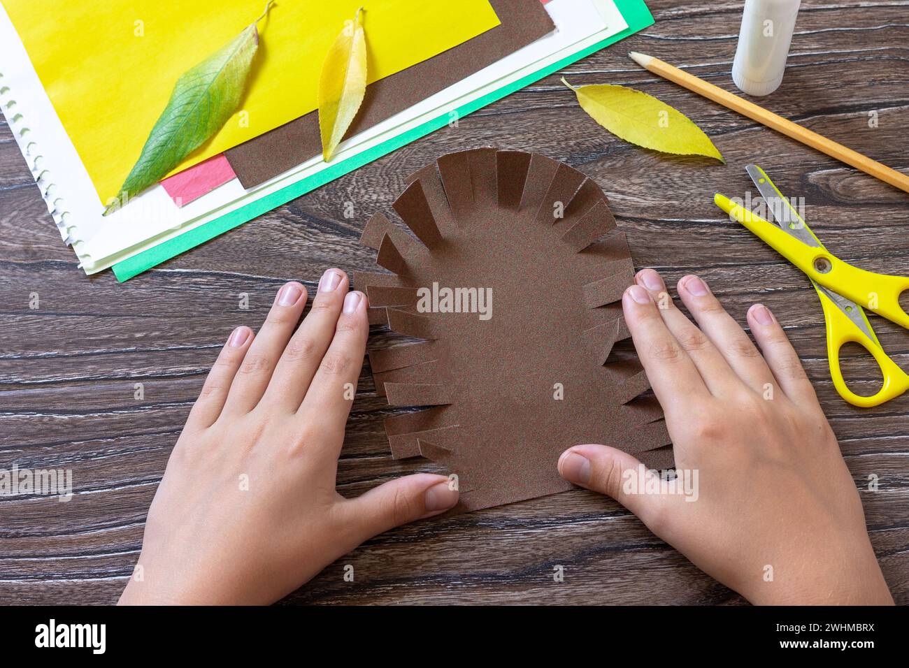 Instruction step 3. Postcard hedgehog with an apple on a wooden table ...