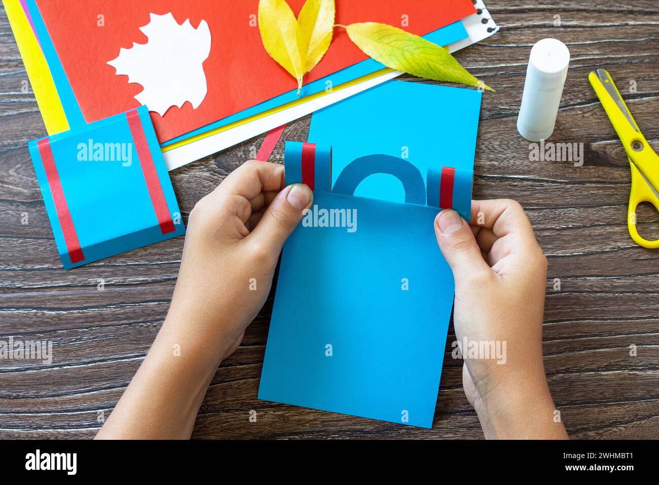 Instruction step 5. Greeting card paper backpack on a wooden table ...